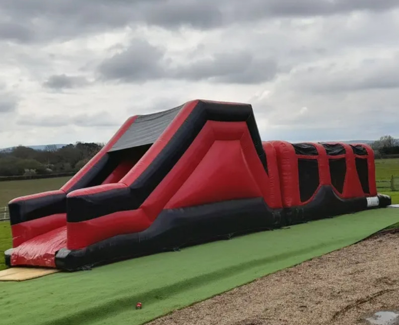 Red & Black Inflatable Assault Course Hire | Lewes & East Sussex