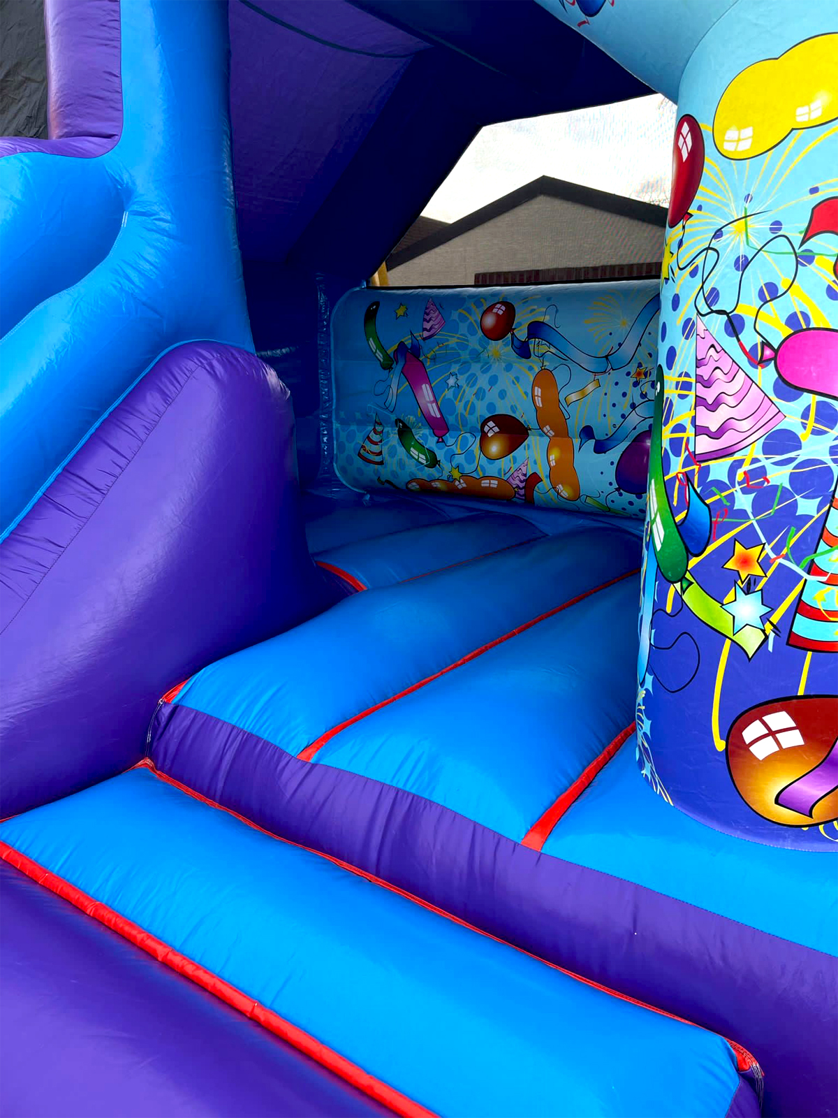 Celebration Front Slide Bouncy Castle Hire in Widnes and surrounding